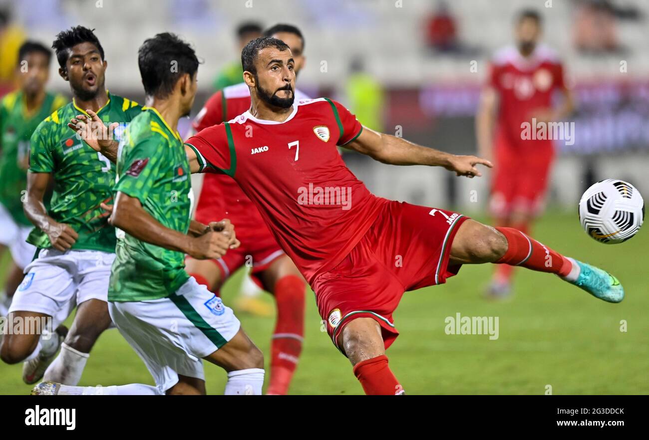Doha, Qatar. 15th June, 2021. Khalid Khalifa Al Hajri (R) of Oman kicks ...