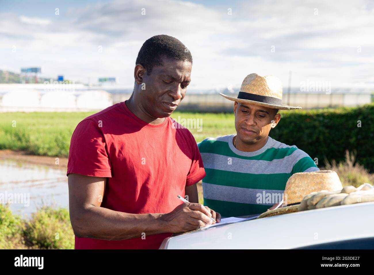 Farmer signing contract with representative of transport company ...