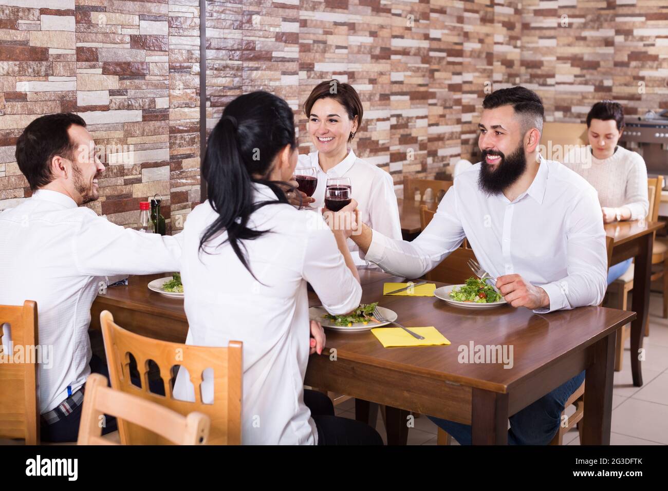 Group of people dining out in restaurant Stock Photo - Alamy