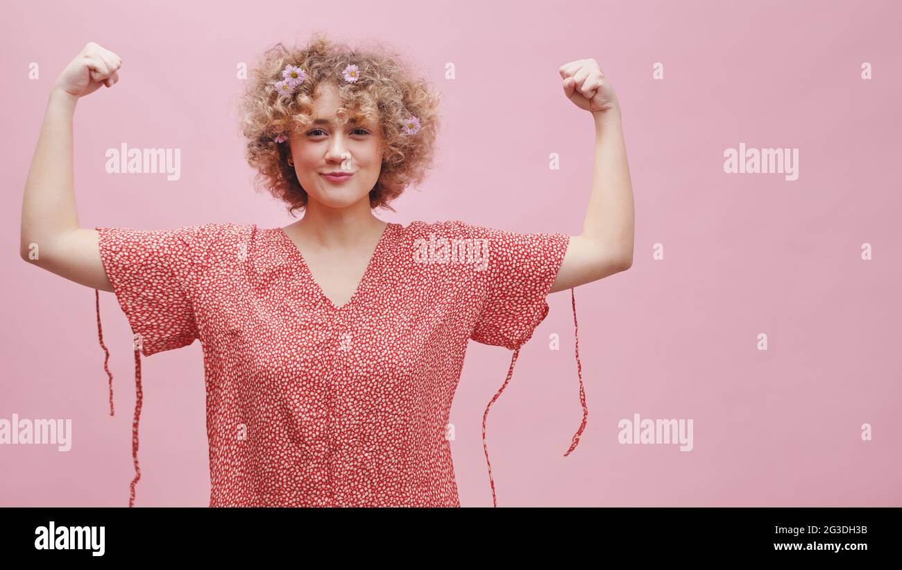 Cute girl showing biceps hi-res stock photography and images - Alamy