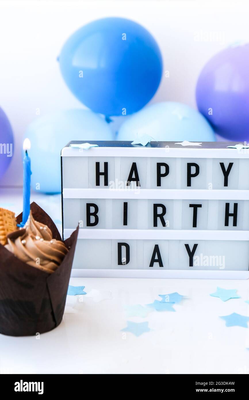 Lightbox with text HAPPY BIRTHDAY and chocolate cupcake candle on ...
