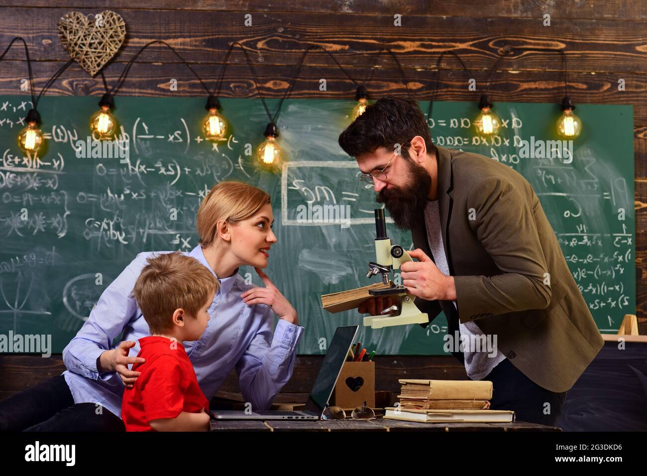 Teacher is sitting at the table in classroom, Teachers who become great ...