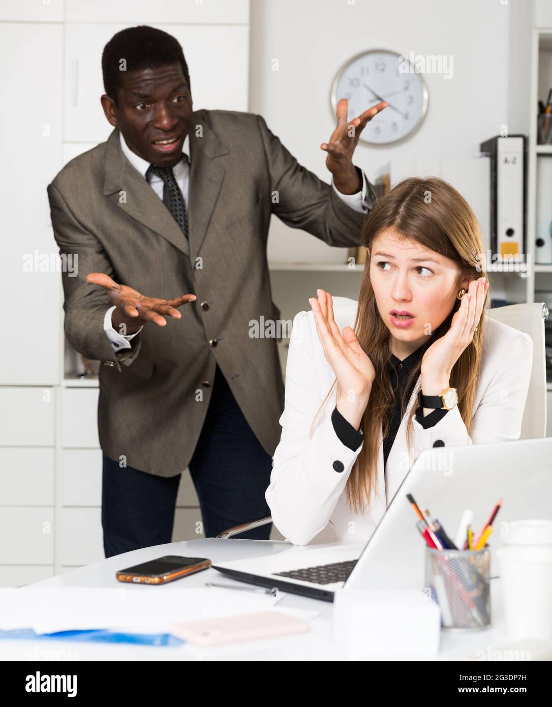 Upset woman with angry boss Stock Photo - Alamy