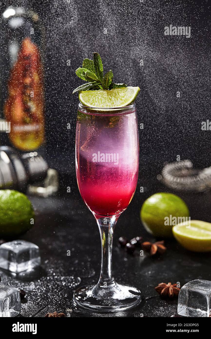 Cocktail with sambuca, white rum, lime juice, soda, currant syrup Stock ...