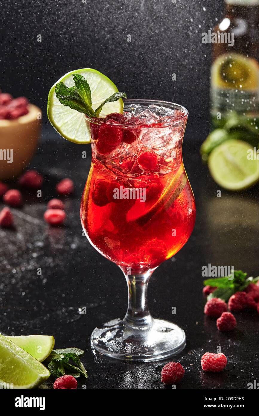 Spritz cocktail with apple cider, campari, raspberries, lime, mint ...