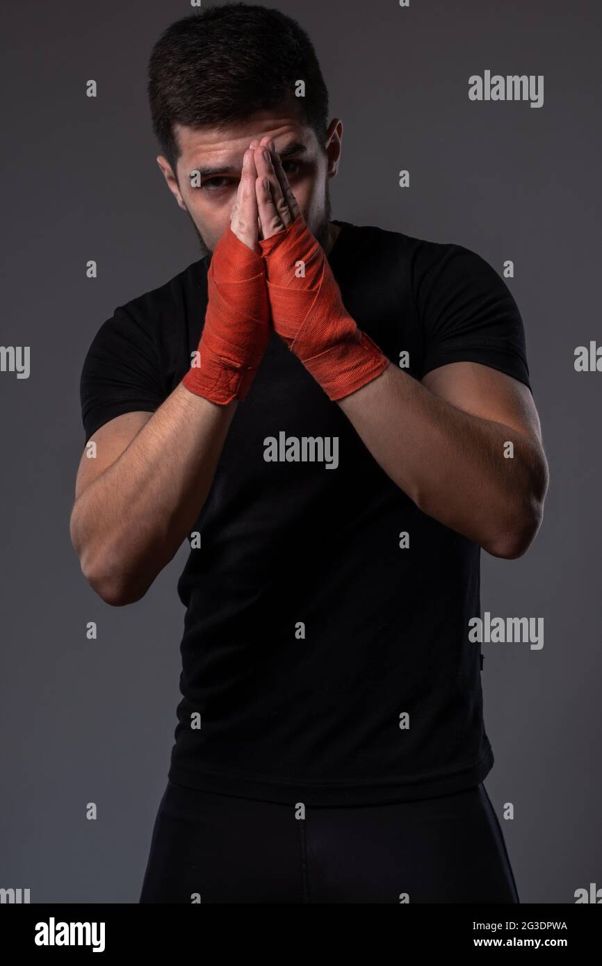 Young MMA fighter with hands folded for praying Stock Photo - Alamy