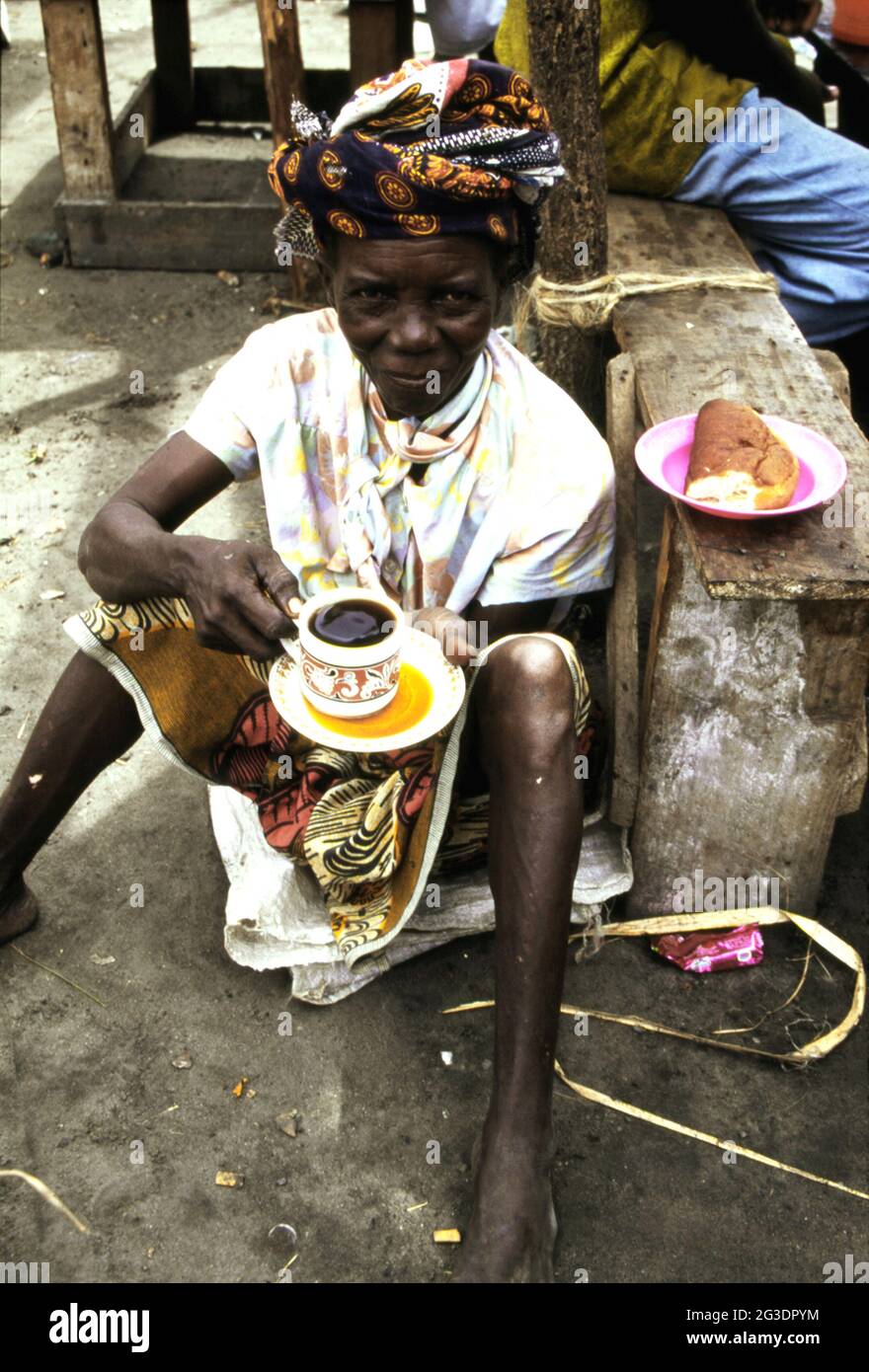 African woman enjoying a cup of very black tea in Dar es-Salaam ...