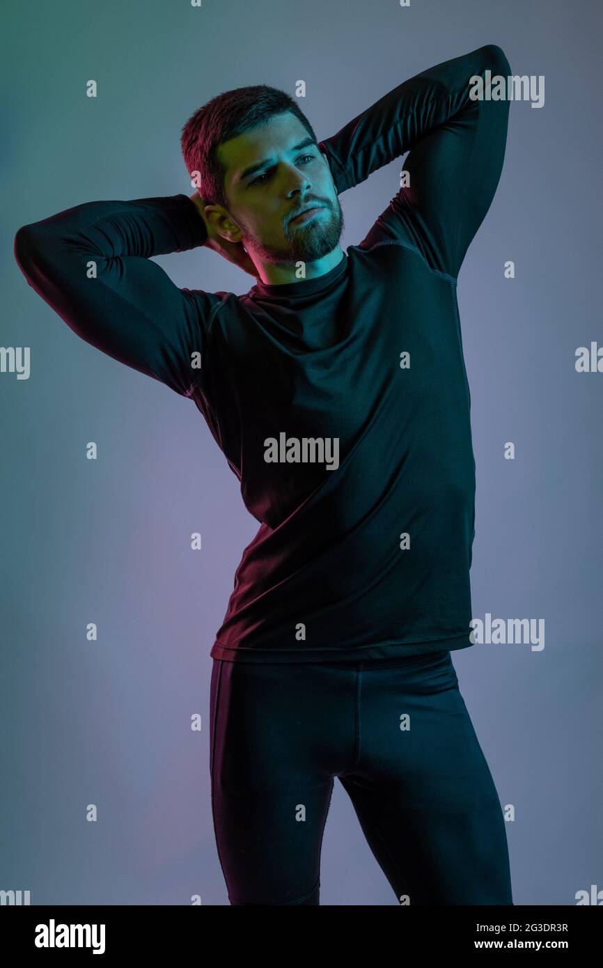 Young muscular man posing on grey background Stock Photo - Alamy