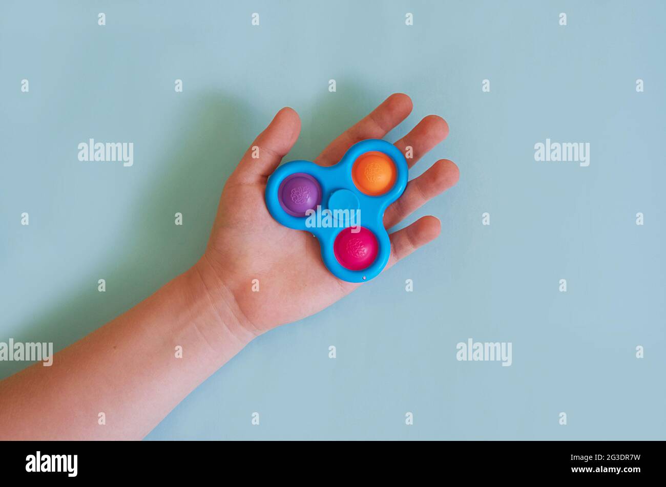 Children's Hand Holding Silicone Toy Spinner Simple Dimple Stock Photo ...
