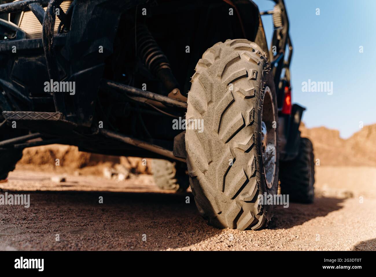 Close-up view of an ATV wheel. ATV in the desert, entertainment Stock ...
