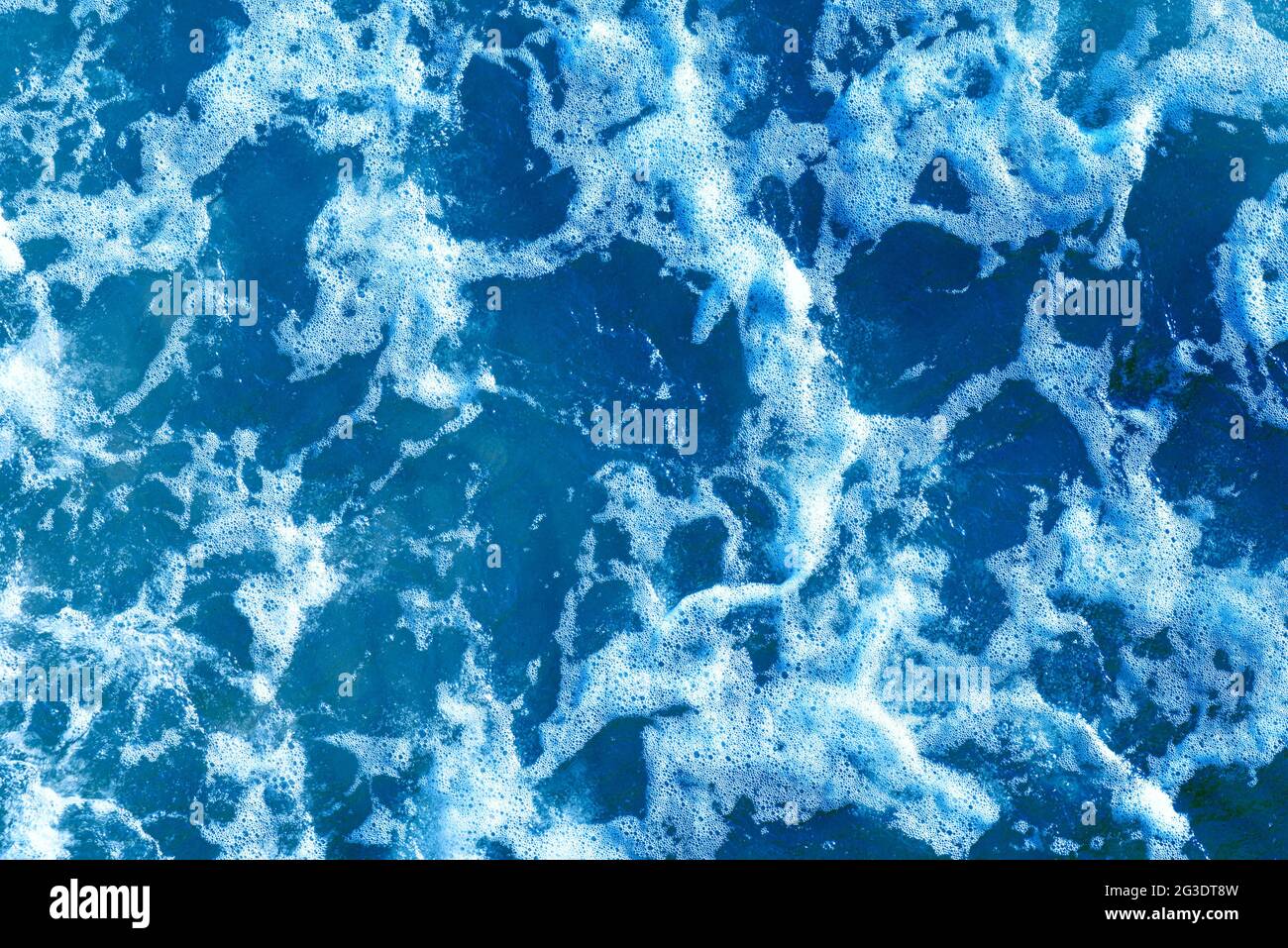 Areal shot of deep blue and rough sea with lot of sea spray.Blue ...