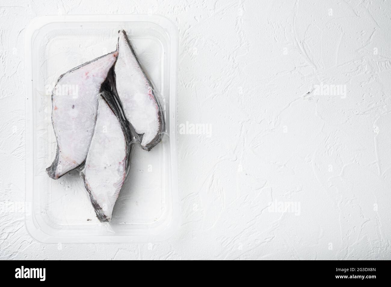 Halibut fish frozen steak pack set, on white stone table background ...