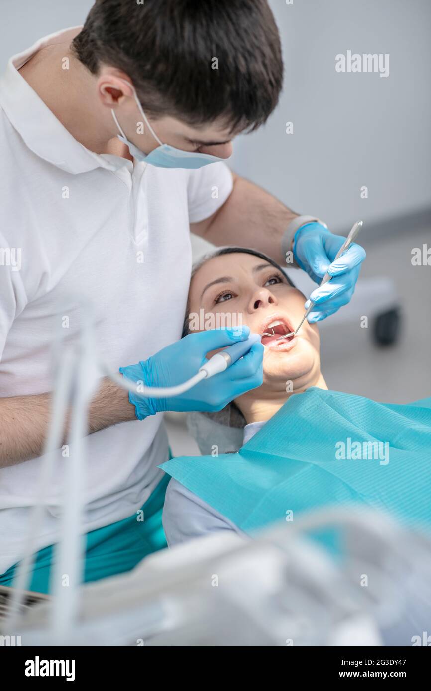 Dentist working on patients teeth restoration and making dental ...