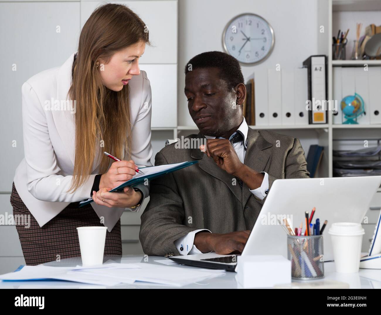 Woman writing down chiefs tasks Stock Photo - Alamy