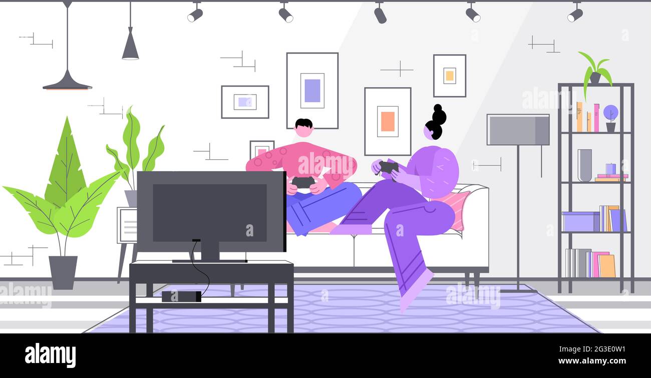 couple having fun playing video games man woman using wireless gamepads ...