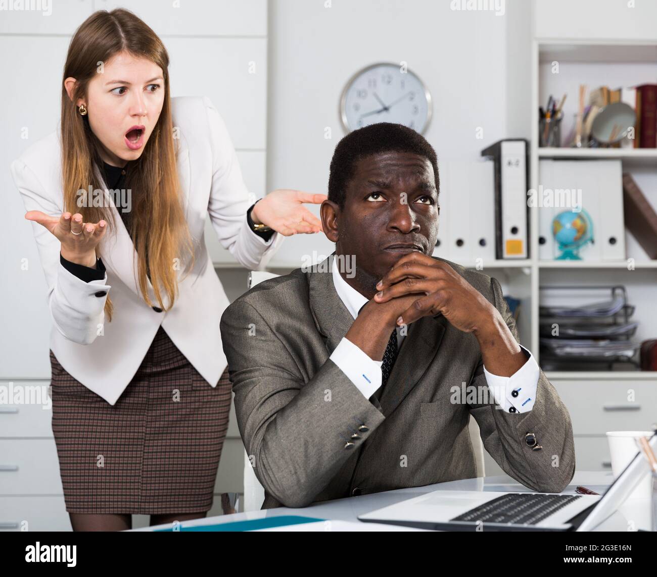 Angry female boss screaming to young male manager during working Stock ...