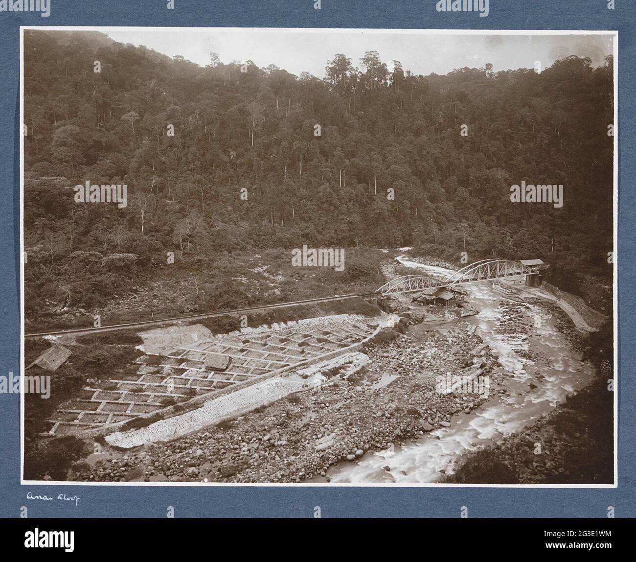 View of a river bed with railroad, rail bridge and fields in the ...