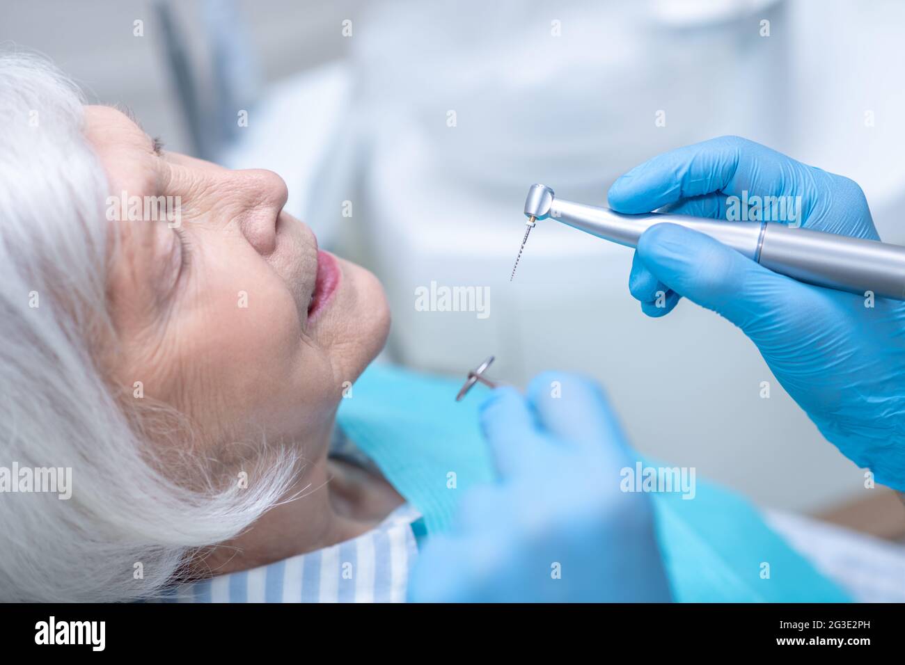 Dentist restoring teeth to the senior female patient Stock Photo - Alamy