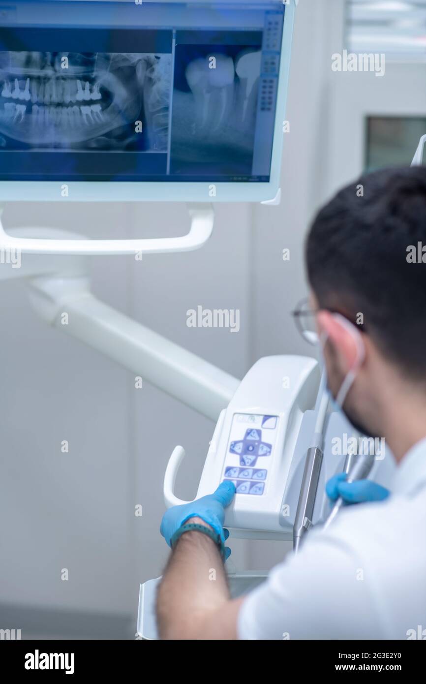 Dentist using dental equipment hi-res stock photography and images - Alamy
