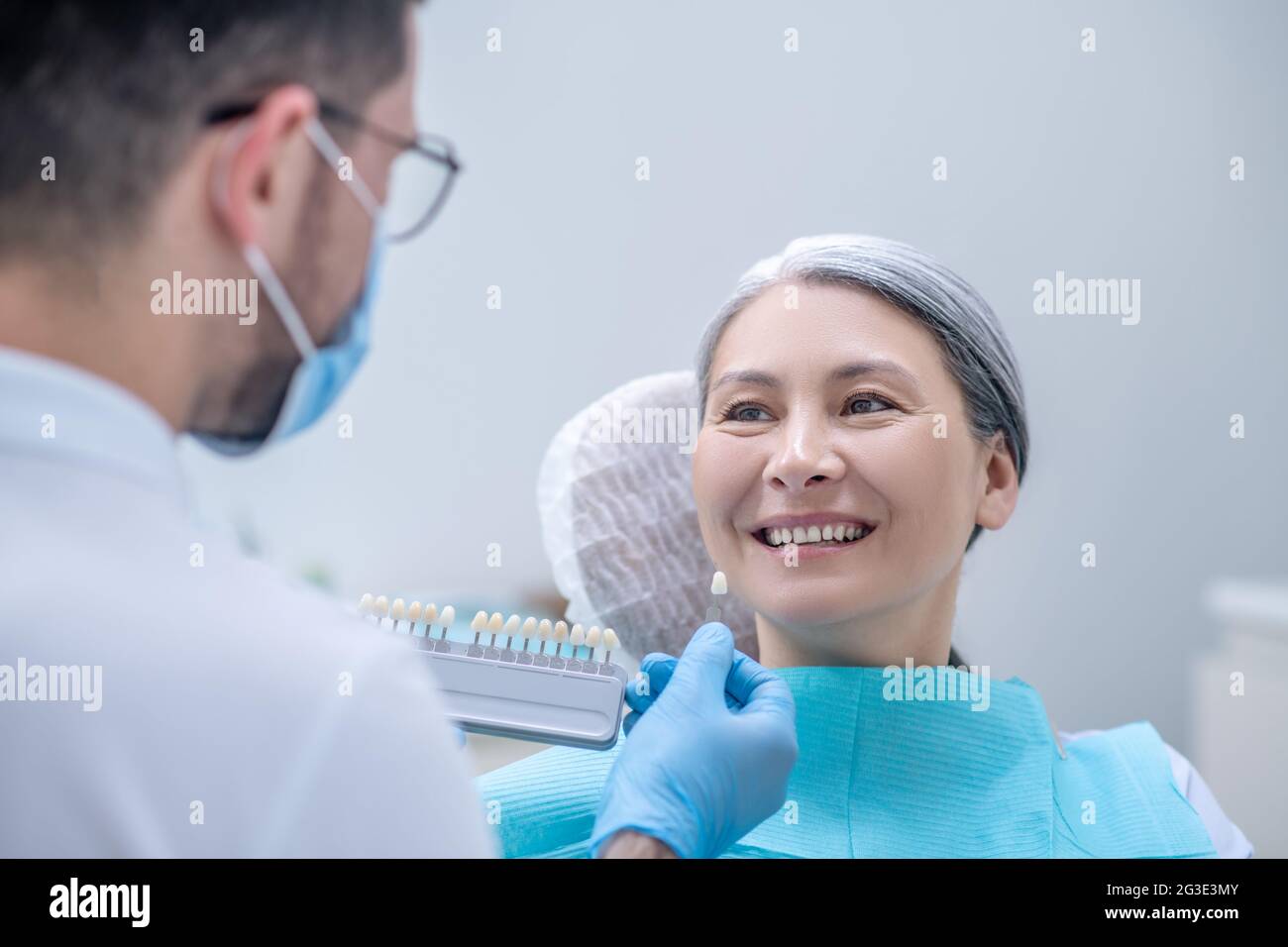Male dentist examining a female patient at the dentists office Stock Photo - Alamy