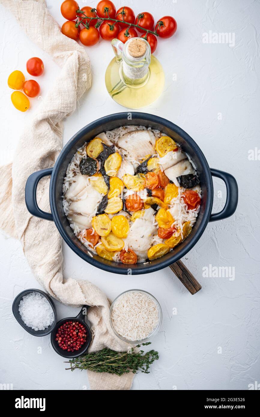 One pan fabulous fish, with basmati rice and cherry tomatoes, on white ...