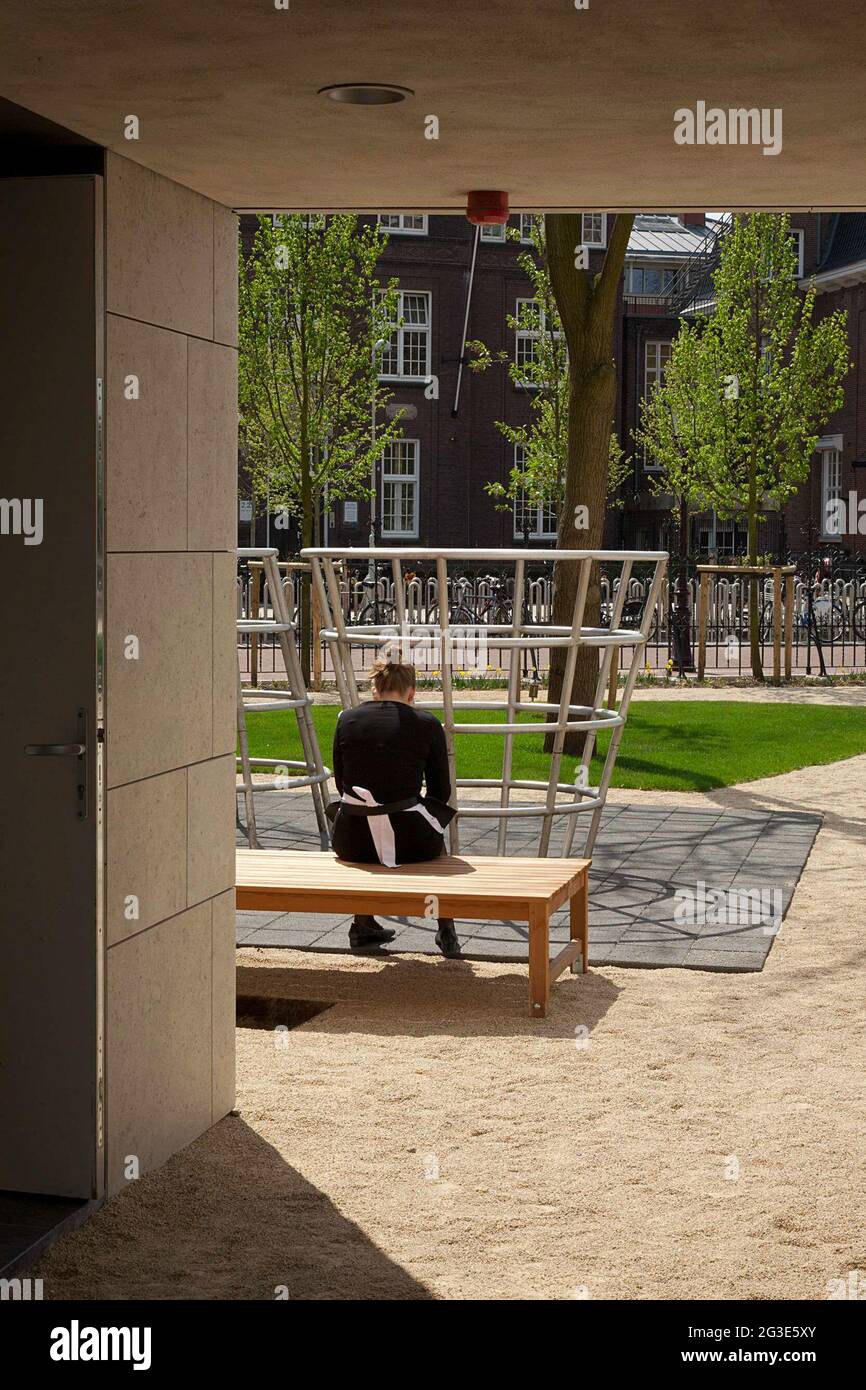 Restaurant employee is sitting on a bench in the garden at a climbing ...