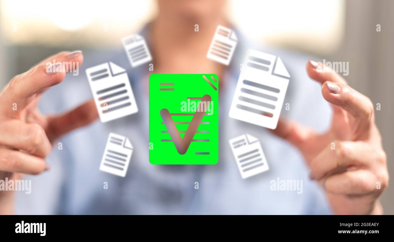 Document validation concept between hands of a woman in background ...