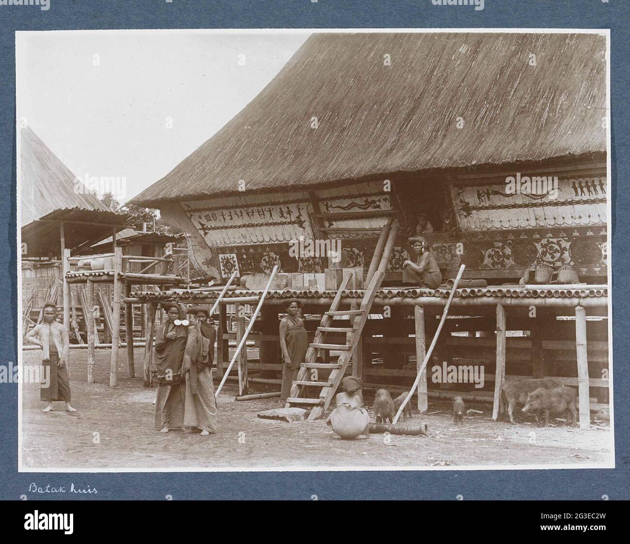 Batak women and children posing for a house on Sumatra. Part of travel ...