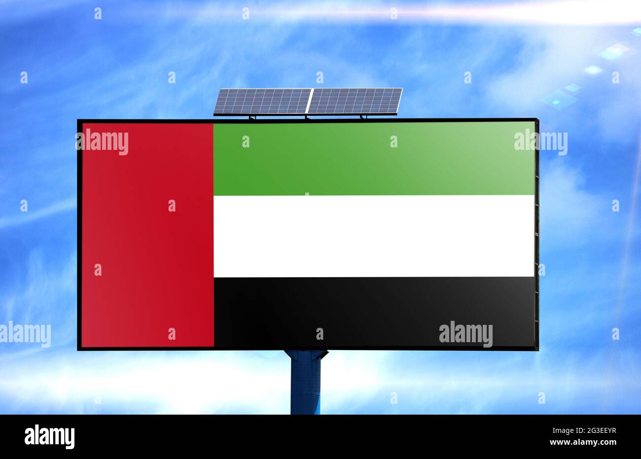 Billboard with United Arab Emirates flag and solar battery on blue sky ...