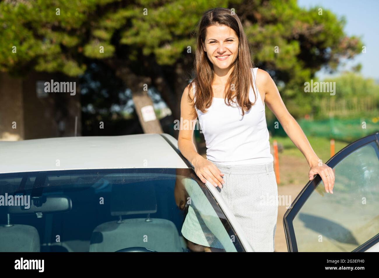 Woman standing near car at sunny day Stock Photo - Alamy