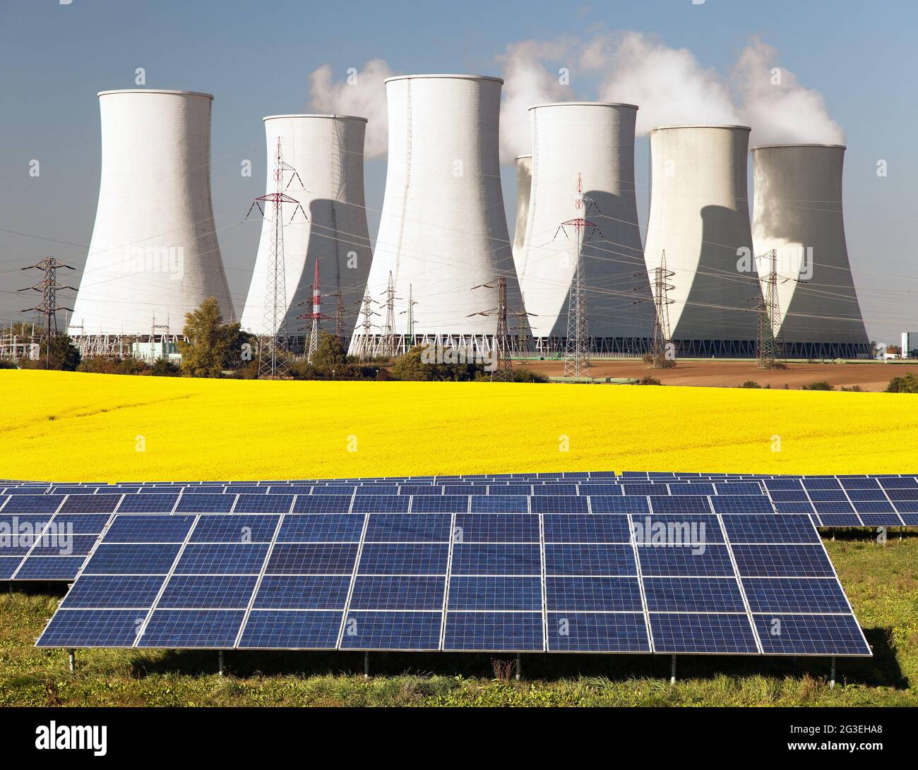 Nuclear power plant with golden glowering field of rapeseed and ...