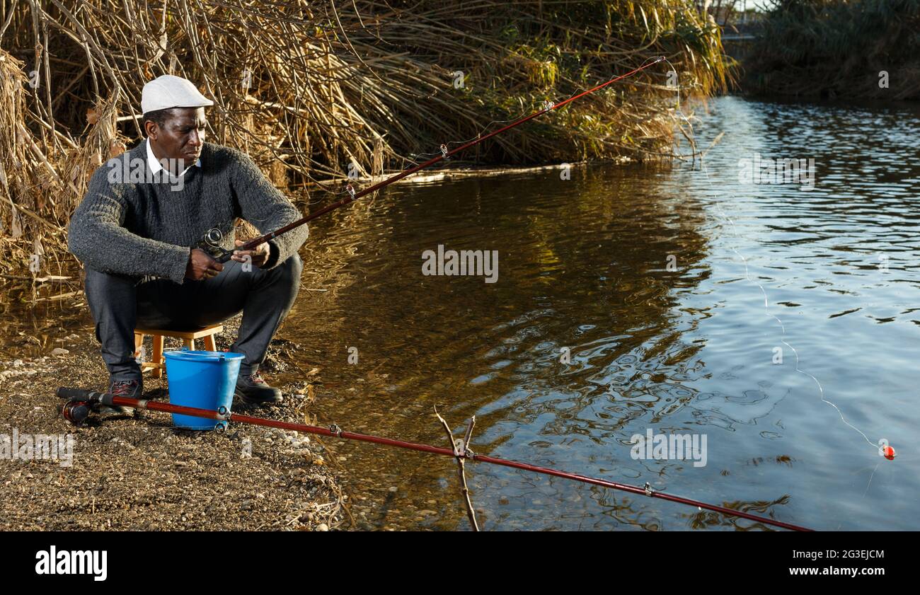 Fisherman sitting near river hi-res stock photography and images - Alamy