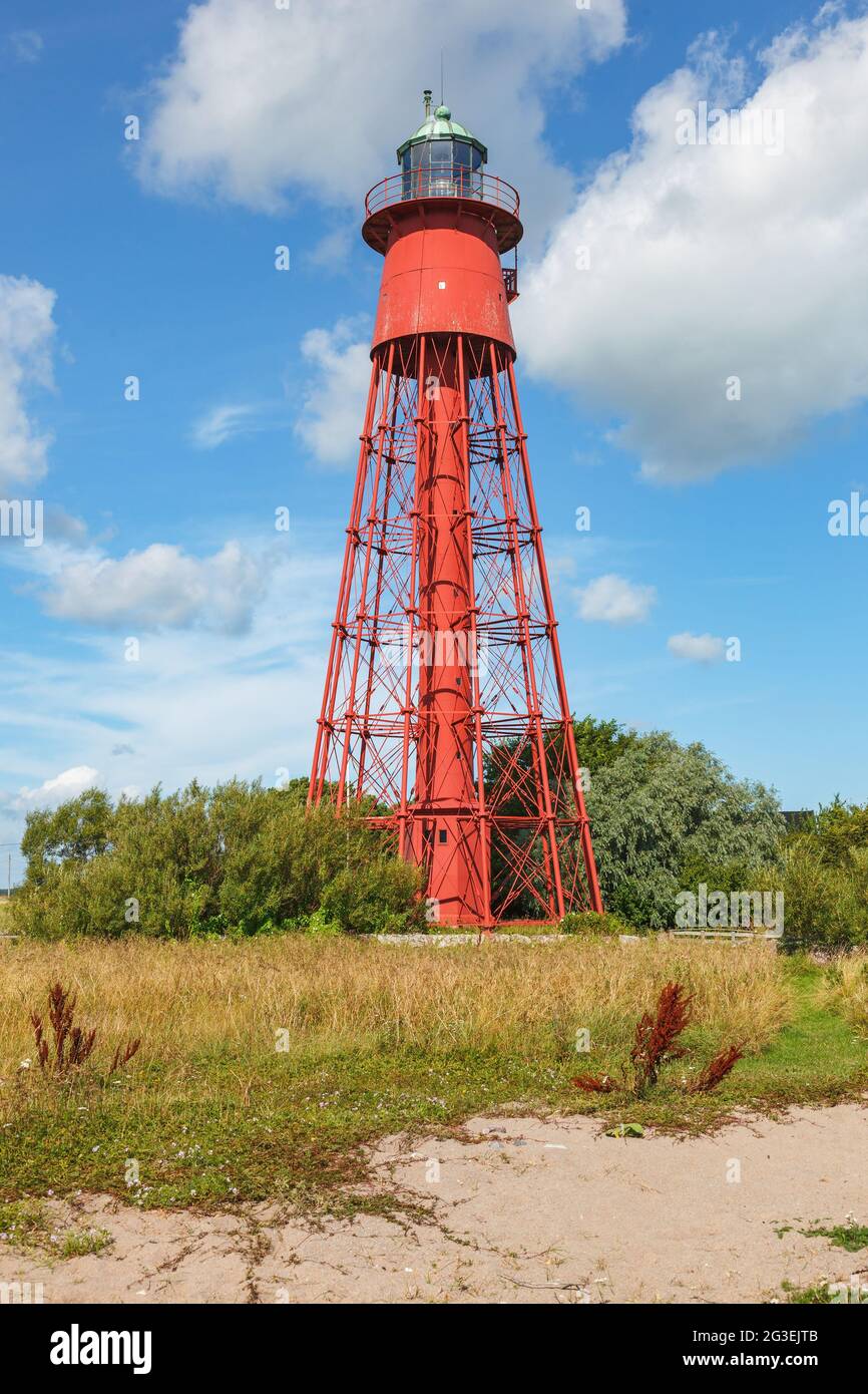 Red steel lighthouse on the sandy beach Stock Photo - Alamy
