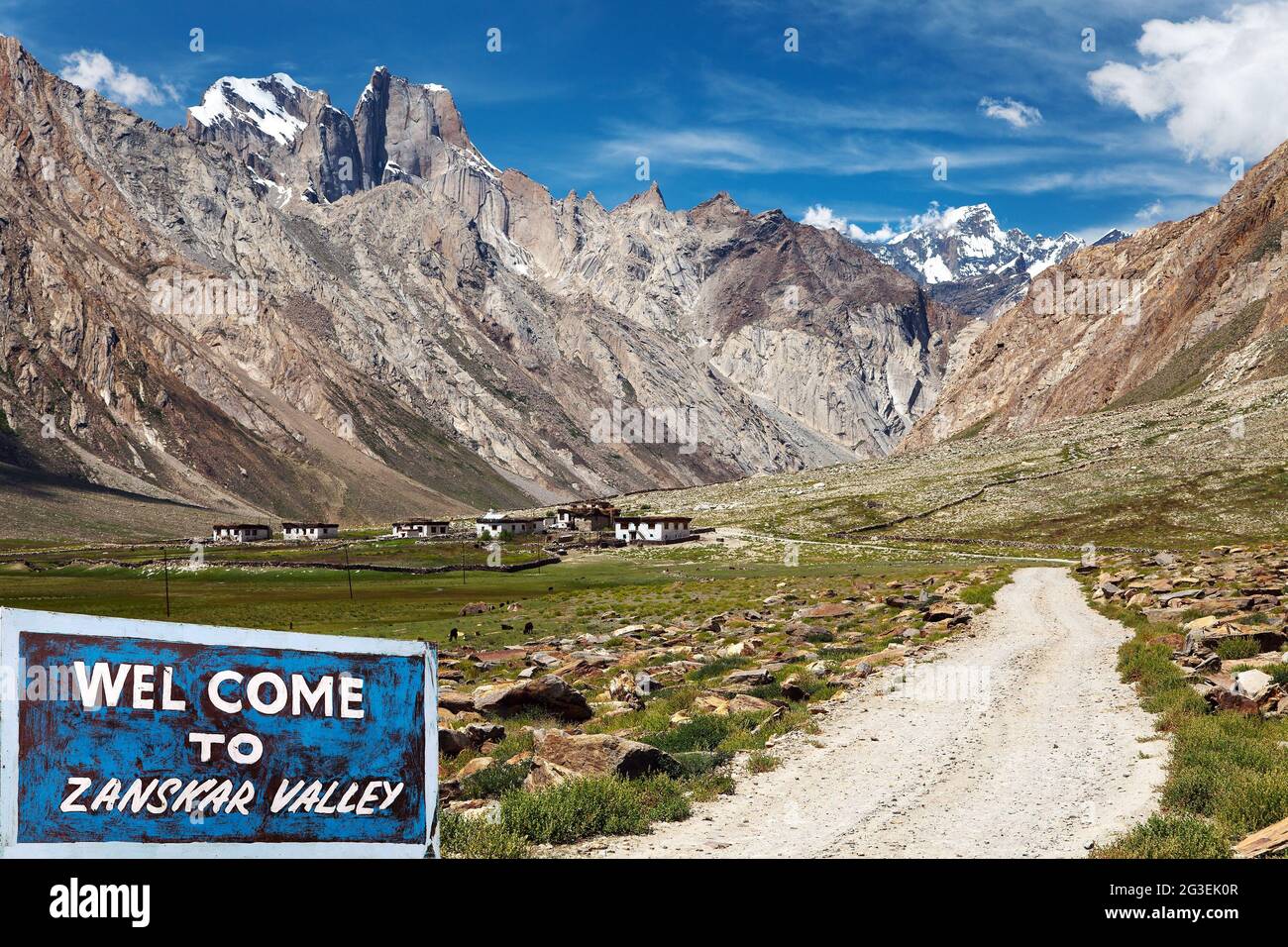 Country road and village in Suru valley and signpost Welcome to Zanskar ...