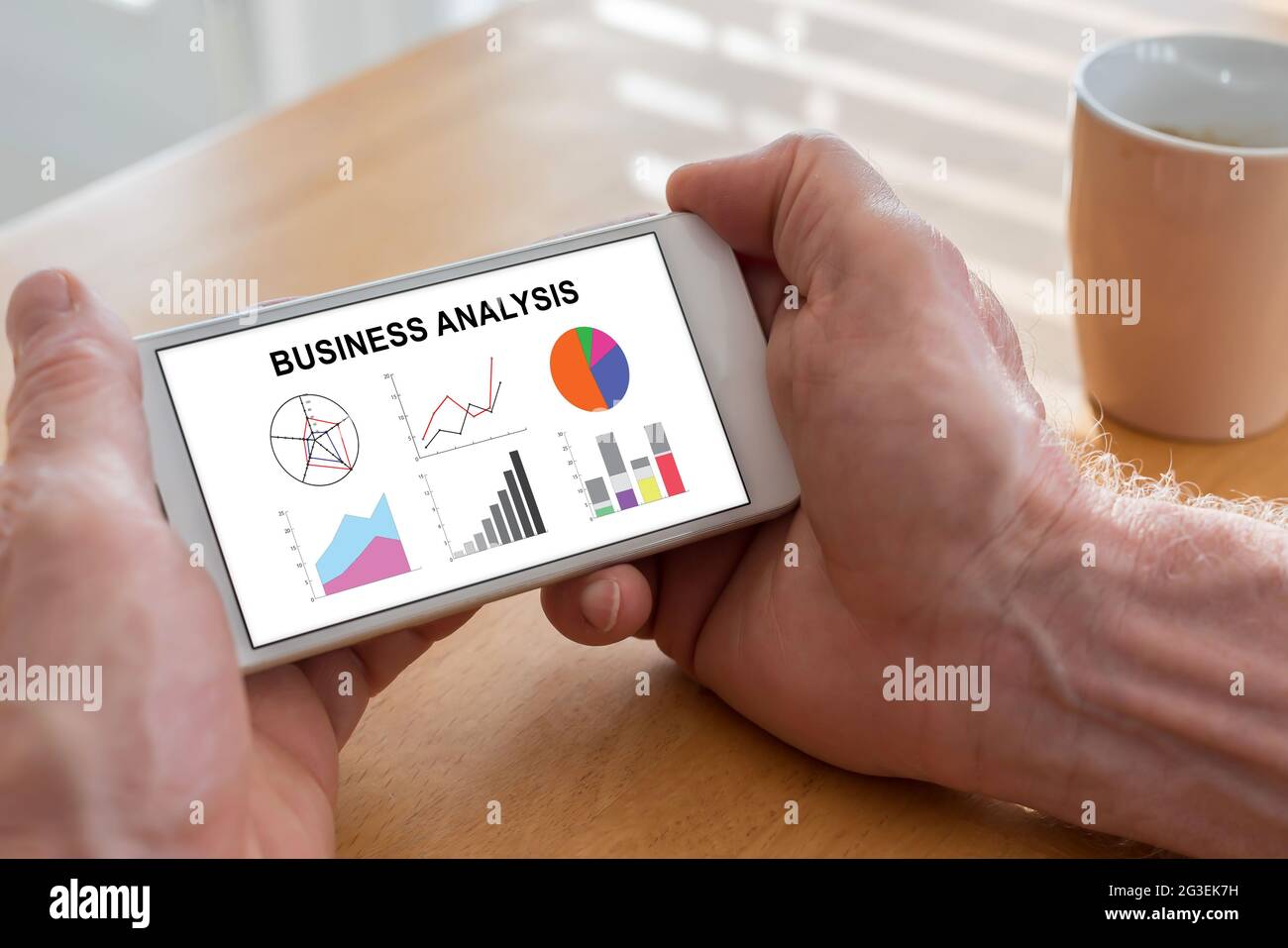 Male hands holding a smartphone with business analysis concept Stock ...
