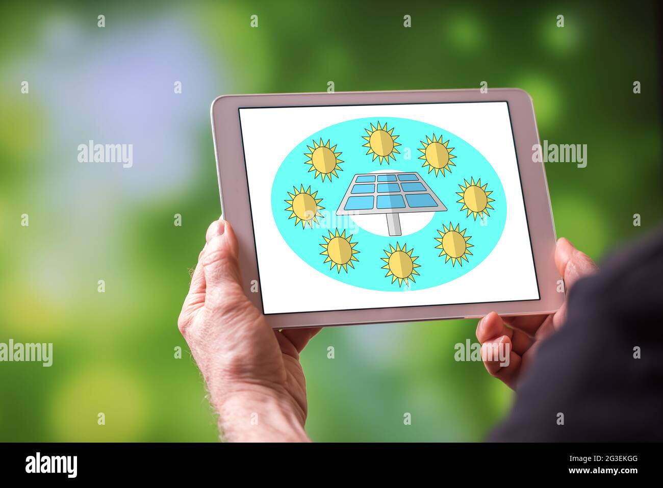 Man holding a tablet showing clean energy concept Stock Photo - Alamy