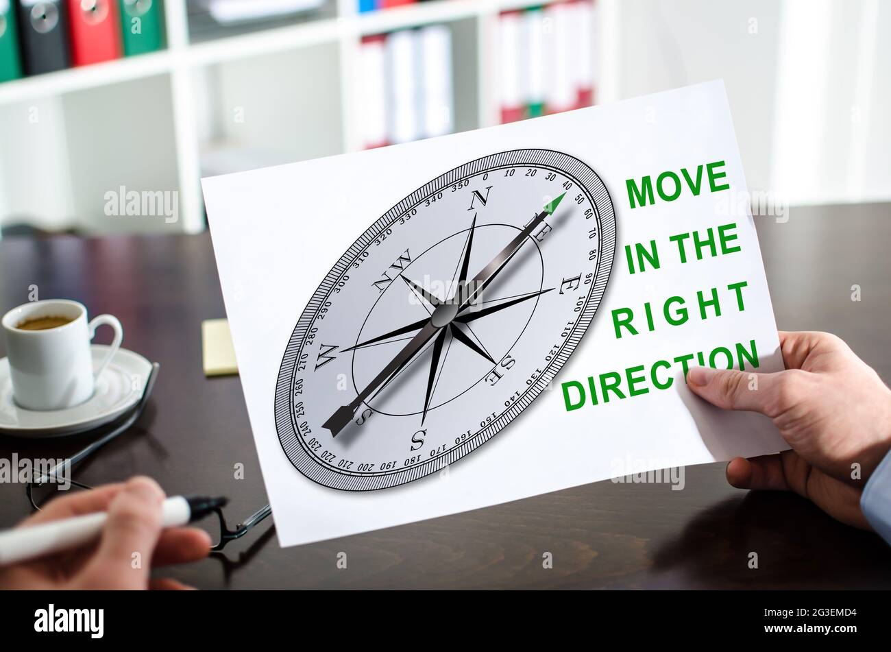 Hand holding a paper showing right direction concept Stock Photo - Alamy