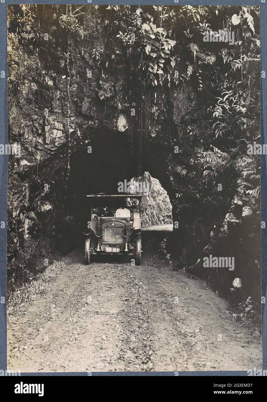 Car passes tunnel on the road from Taroeteng to Sumboga on Sumatra ...