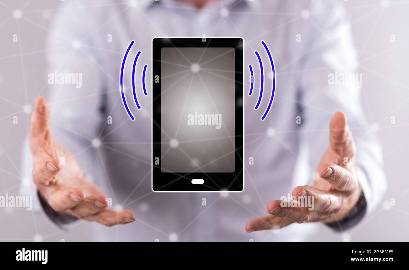 Wireless connection concept above the hands of a man in background ...