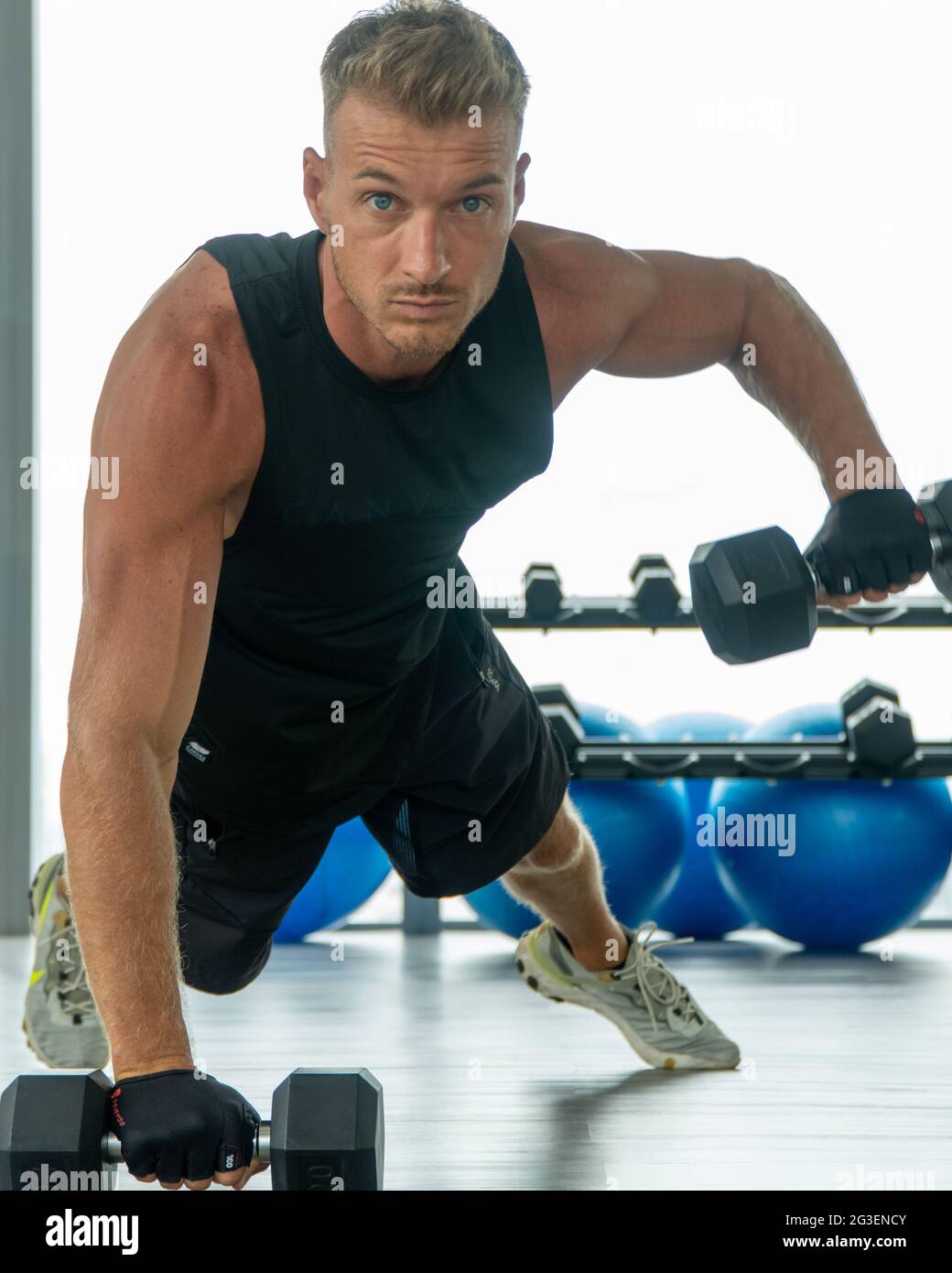 Handsome man with great body gym and pool Stock Photo - Alamy