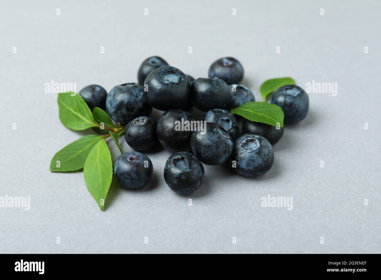 Fresh blueberry with leaves on gray background Stock Photo - Alamy