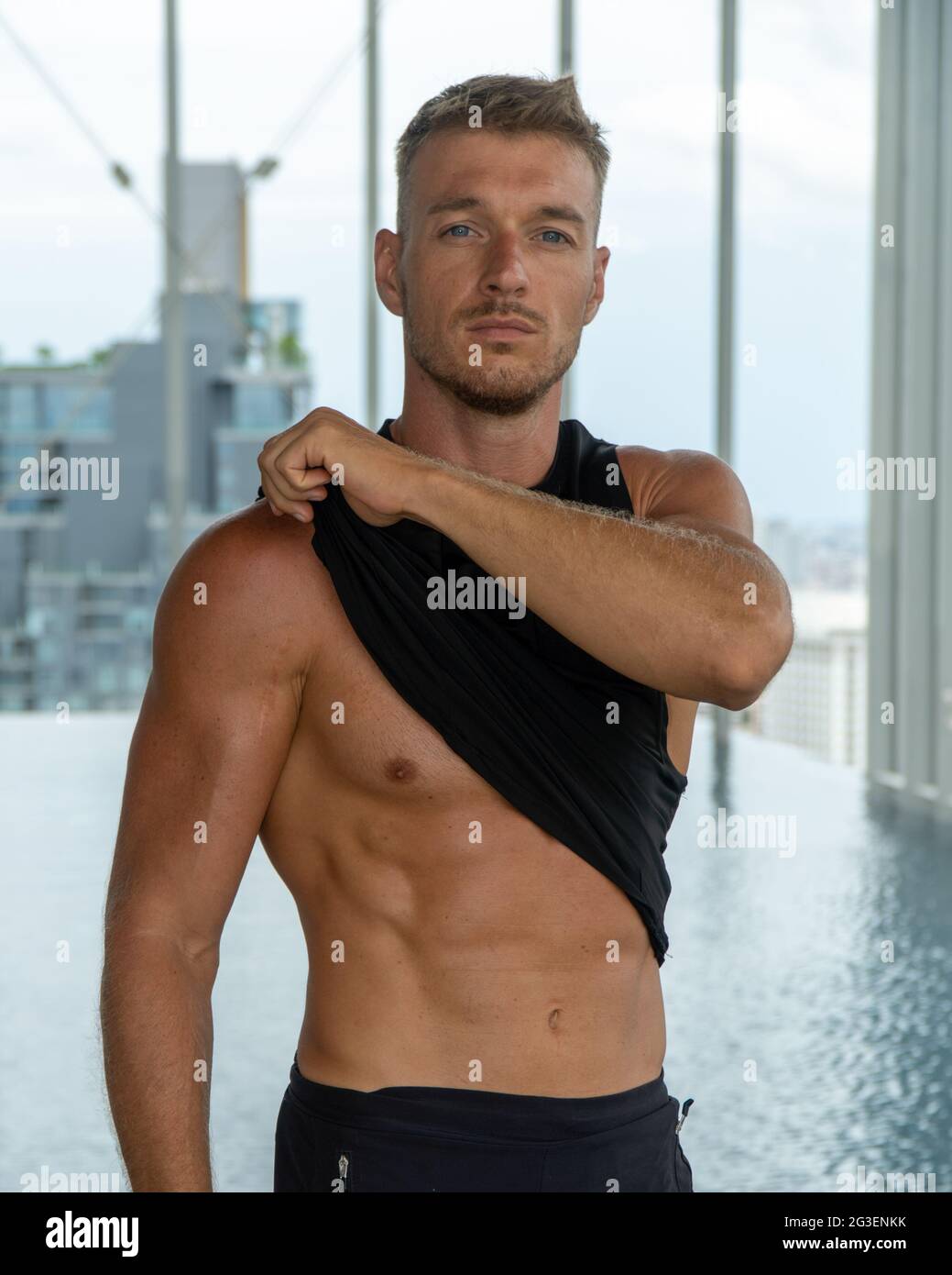 Handsome man with great body gym and pool Stock Photo - Alamy