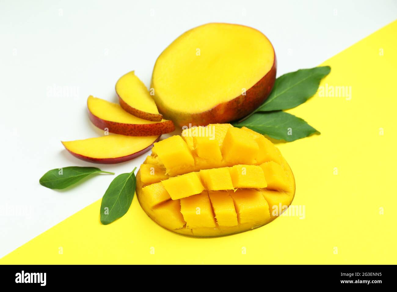 Ripe mango fruit on two tone background Stock Photo - Alamy
