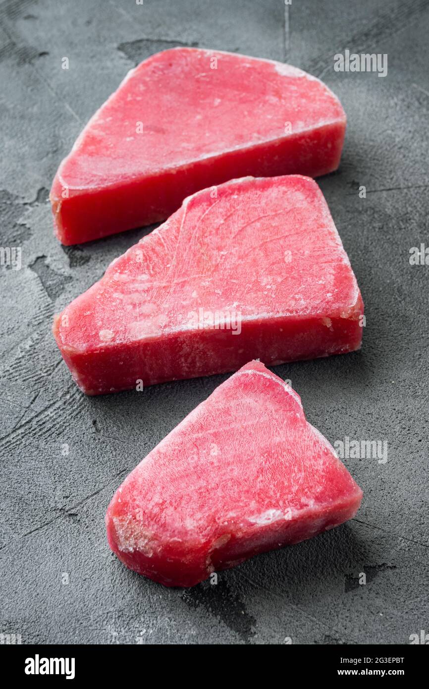 Raw frozen tuna fish fillet set, on gray stone background Stock Photo ...