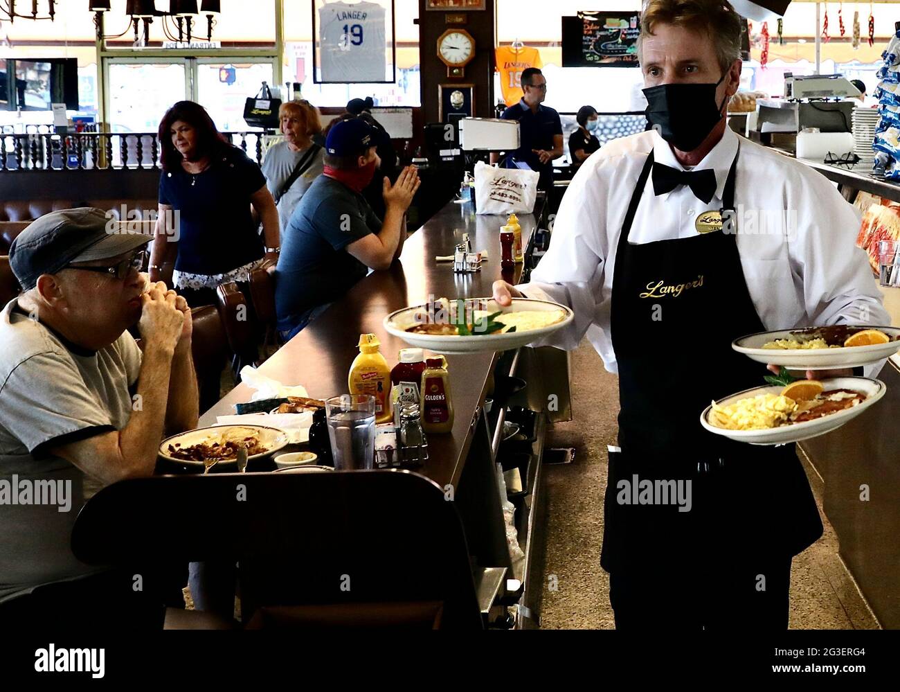 Los Angeles, USA. 16th June, 2021. A waiter serves food at the Langer's ...
