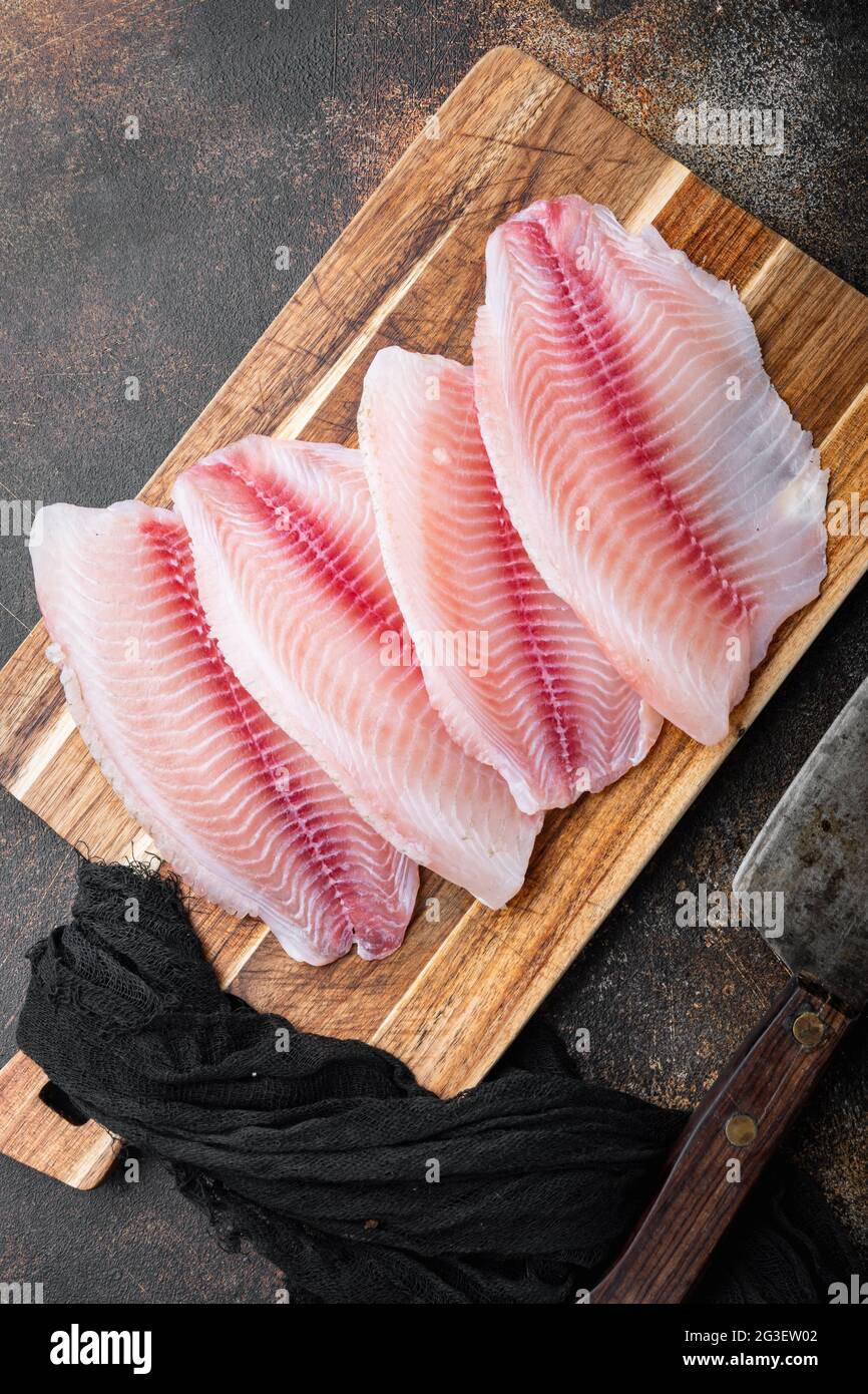 Tilapia fish, skinless meat, on old rustic background, top view Stock ...