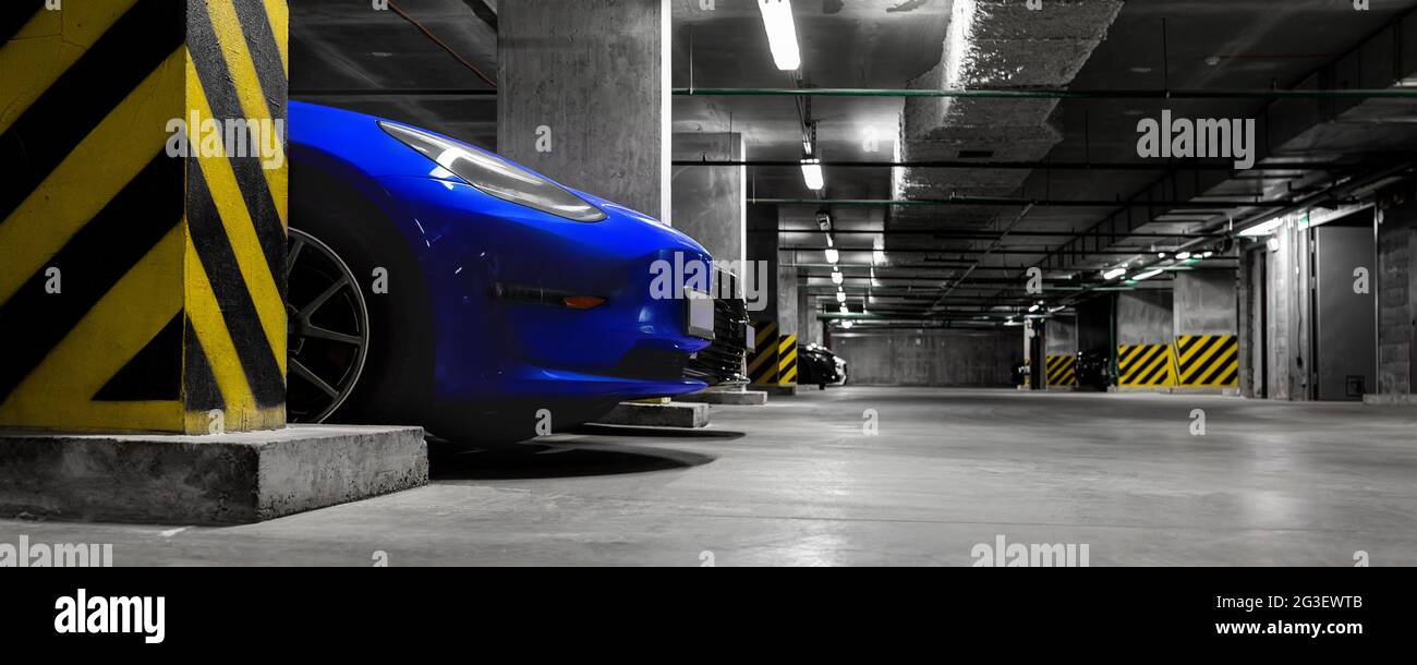Dark scenic car park underground multilevel garage interior. Concrete ...