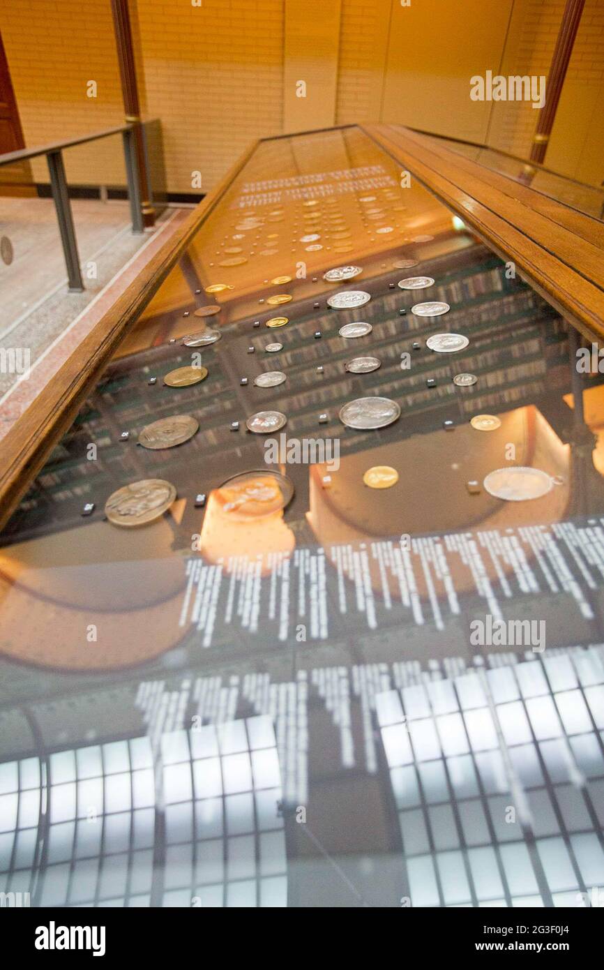 Detail display with coins and tokens on library bordes Stock Photo - Alamy