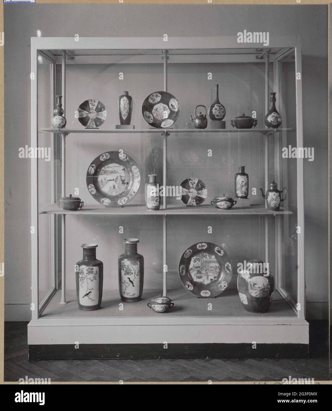 Showcase with various objects including dishes and pots; Trial setup ...
