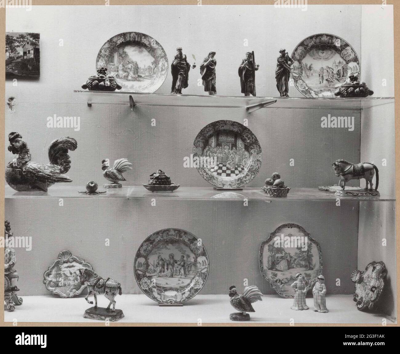 Showcase with objects of ceramics including dishes and images of animal ...